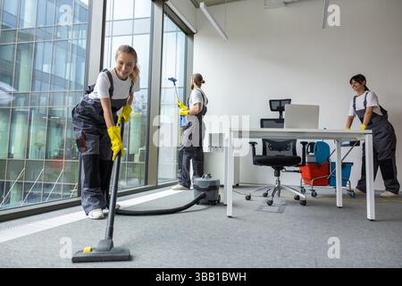 Housekeeping team cleaning the conference room and looking busy and ...