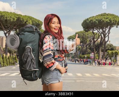 Asian woman tourist with backpack exploring urban environment for ...