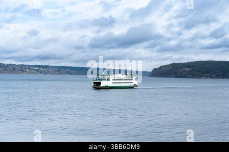 A scenic view of a ferry crossing Puget Sound at sunset in Washington ...