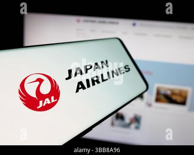 In this photo illustration a Japan Airlines logo seen displayed on a ...