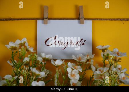 Congrats text on paper card with flower decoration on wooden background ...