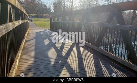 The Culham Trail Bridge spans a calm waterway, reflecting the structure ...