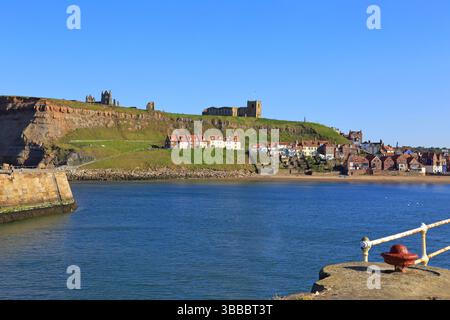 Whitby harbour entrance with St Mary's Church and Whitby Abbey on East ...