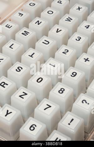 Close-up of white keyboard keycaps with letters, numbers, and symbols ...