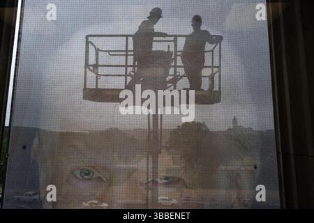 Washington, United States. 14th May, 2025. Workers secure an enormous ...