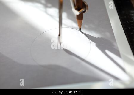 Girl drawing circle with pair of compasses and pencil maths skills ...