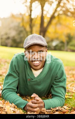 Young male in warm sweater and sunglasses standing near transparent ...