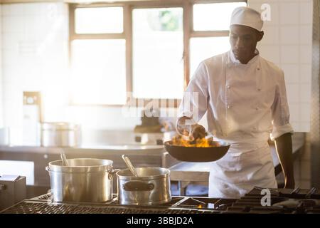 Frying pan on the gas stove in a kitchen Stock Photo - Alamy