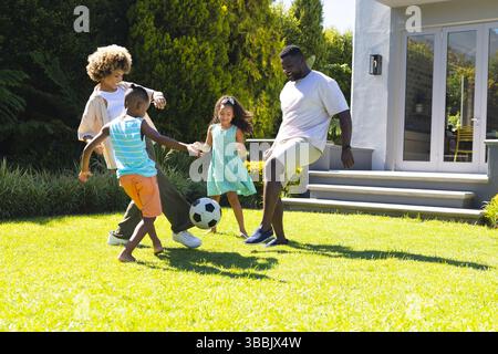 Diverse family playing outdoors in autumn park with child Stock Photo ...