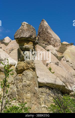 Cappadocia’s fairy chimneys stand tall in a rugged basin. Nature’s ...