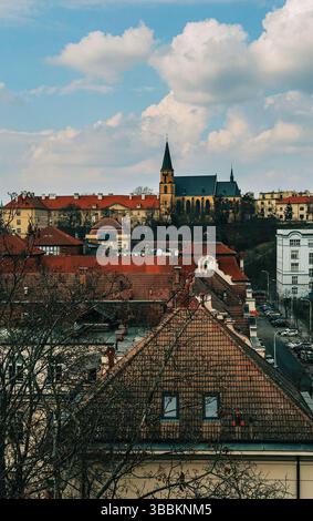 Spring view of red brick gothic church with twin spires framed by fresh ...