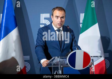 French Armed Forces Minister Sebastien Lecornu (R) discusses with ...