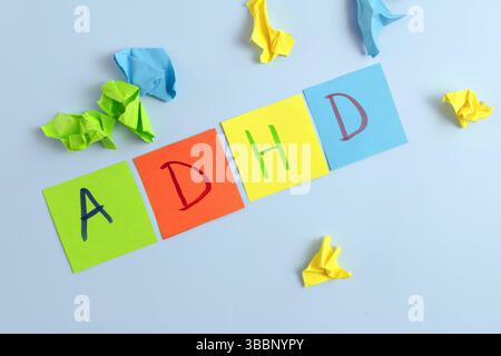 ADHD abbreviation on multi-colored paper and toy banana. Attention ...