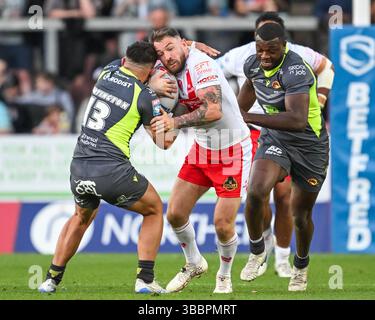 Daryl Clark of St. Helens is tackled during the Betfred Super League ...