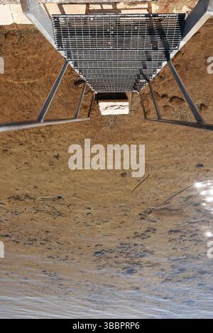 A construction worker is seen on a ladder on a building under ...