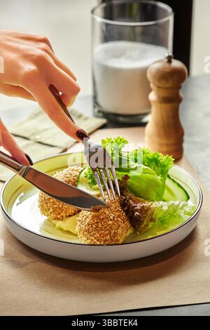 Crispy golden brown breaded cutlets on textured white plate garnished ...