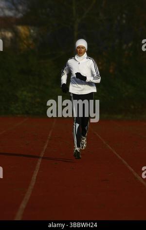 A running woman on a stadium, Coburg Stock Photo - Alamy
