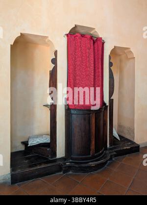 Simple wooden confessional in a church closeup detail, nobody, no ...