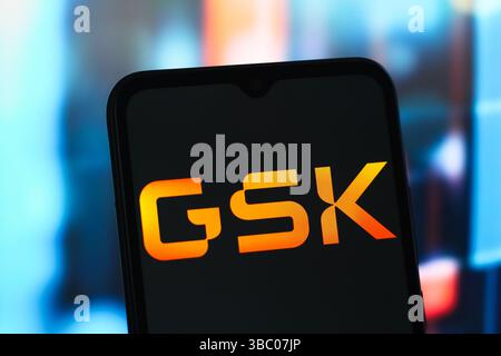 In this photo illustration, the GSK logo is displayed on the screen of ...