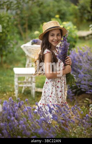 girl child is in the lavender flower field, beautiful summer landscape ...