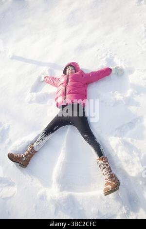 Girl makes snow angel Stock Photo - Alamy