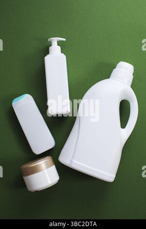 Plastic bottle of washing liquid, garbage bags, brushes and a white ...