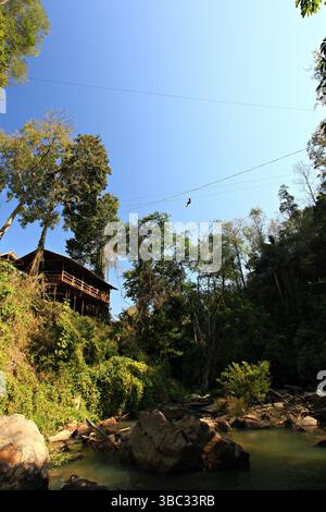Asian tourists adventure on a zip line in Ban Mae Wang, Chiang Mai ...