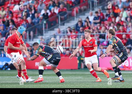 Jack Crowley of Munster passes the ball during the Investec Champions Cup Round 2 match between ...