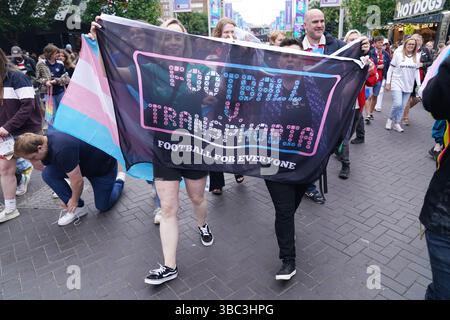 Fans walk with a Football v Transphobia flag on Wembley Way ahead of ...