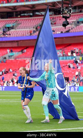Chelsea goalkeeper Hannah Hampton (left) clears the ball under pressure ...