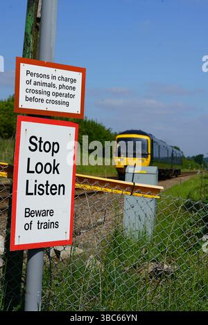 Signs at railroad crossings warning of an approaching train. Dorking ...