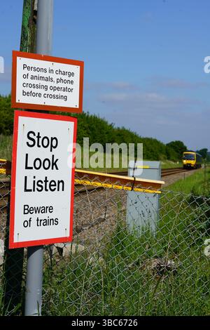 Signs at railroad crossings warning of an approaching train. Dorking ...