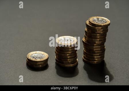 Stacks of British currency arranged on a textured surface during a ...