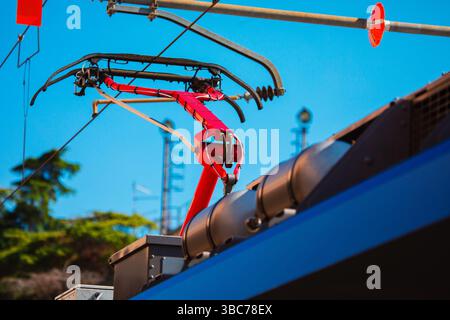 An overhead pantograph device mounted on a public transit vehicle ...
