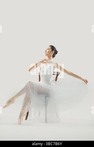 a ballet dancer leaning on a chair while dancing Stock Photo - Alamy