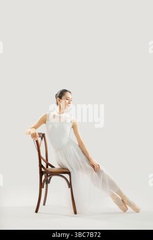 a ballet dancer leaning on a chair while dancing Stock Photo - Alamy
