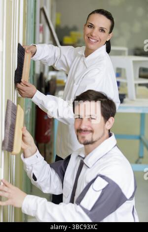 Team of painters working together on a artwork next to isolated mockup ...