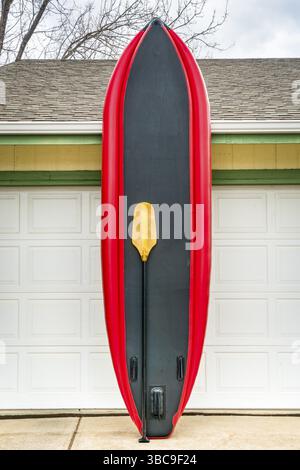 Whitewater inflatable stand up paddleboard with a kayak paddle isolated ...