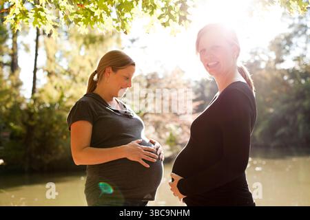 Pregnant sisters Hadley and Sarah outdoors Stock Photo - Alamy