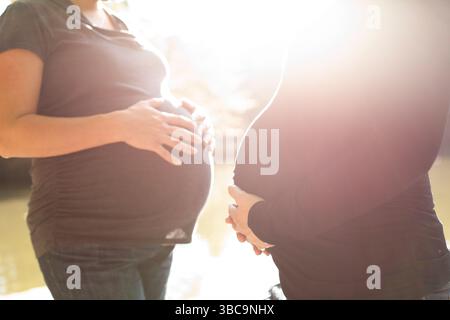 Pregnant sisters Hadley and Sarah outdoors Stock Photo - Alamy