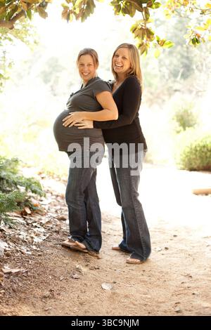 Pregnant sisters Hadley and Sarah outdoors Stock Photo - Alamy