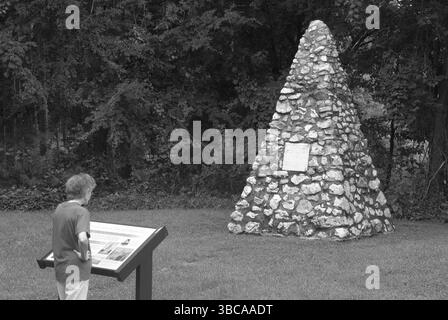 Caucasian woman reading a commemorative marker at the original ...