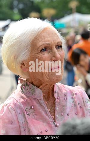 Dame Mary Berry, at the RHS Chelsea Flower Show holding a rose that is ...