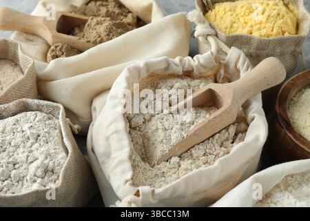 Different types of flour in bags on grey table, closeup Stock Photo - Alamy