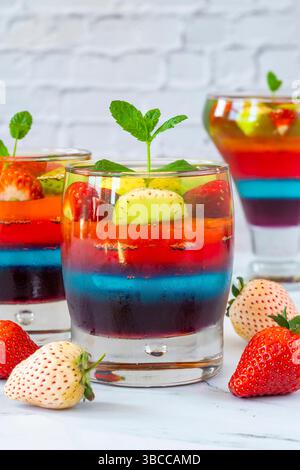 Homemade layered rainbow fruit jelly with fresh fruit Stock Photo - Alamy