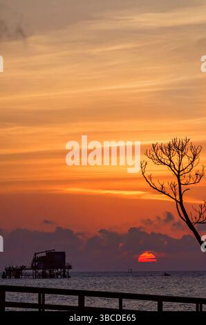 Dauphin Island, Alabama, USA - May 16, 2025: The sun sets on an ...