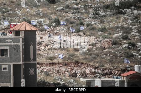 Salfit, Palestine. 19th May, 2025. Jewish settlers raise Israeli flags ...