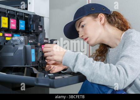 technician inspecting ink in industrial photocopier Stock Photo - Alamy