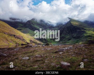 A tranquil mountains scenery under the cloudy sky Stock Photo - Alamy