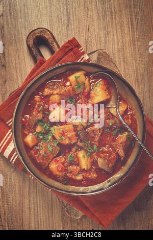 Tasty beef baked with potatoes and stewed peppers served Stock Photo ...